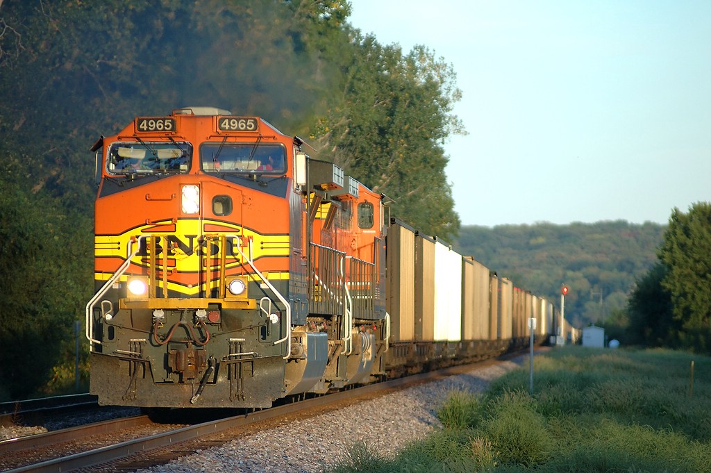 BNSF 4965, strong sun greets the westbound empty hopper train